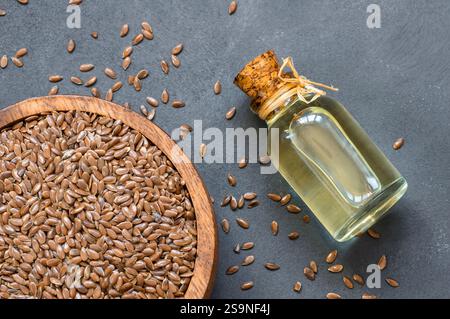 Linseed oil and bowl of linseeds on wooden background Stock Photo - Alamy