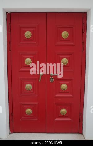 Beautiful red doors with metal decorations. The color of luxury. The ...