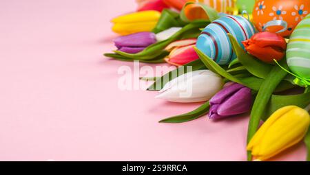 Pink tulips flowers and colourful eggs on pink background. Card for ...