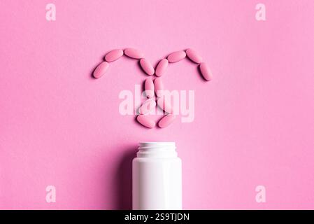 Uterus made of pink pills, minimal concept of female health on pink ...