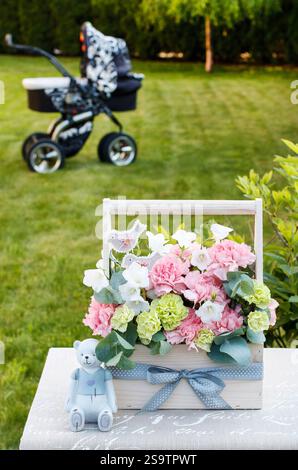 Floral arrangement in a wooden box with live spruce and ilex branches ...