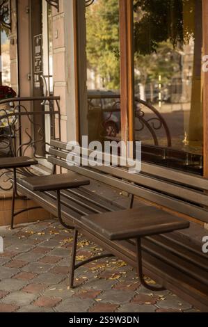 tables and benches near a street cafe Stock Photo - Alamy
