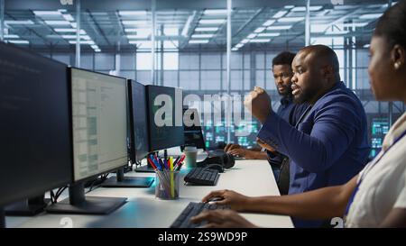Surprised data center technician celebrating after successfully ...