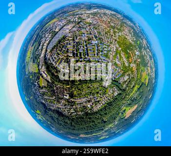 Aerial shot of a cityscape with a lot of buildings surrounded by rocky ...