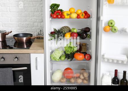 Big open fridge with different fresh products in modern kitchen Stock ...