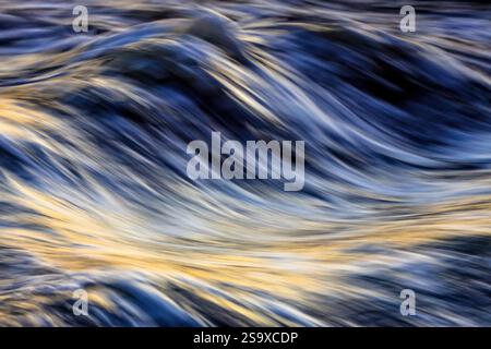 Fast moving water with slow shutter speed with warm sunset gold ...