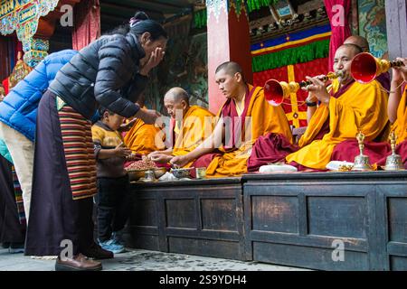 Pilgrims receive rilbu pills at the Empowerment (Wong) during Mani ...