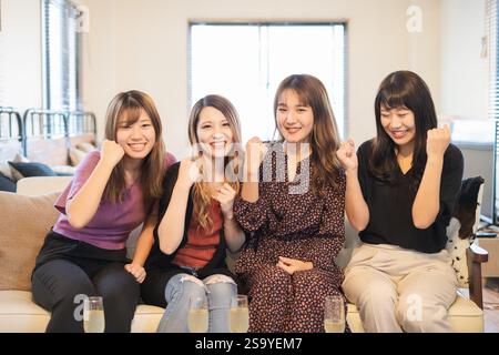 Four women watching a sports match indoors Stock Photo - Alamy
