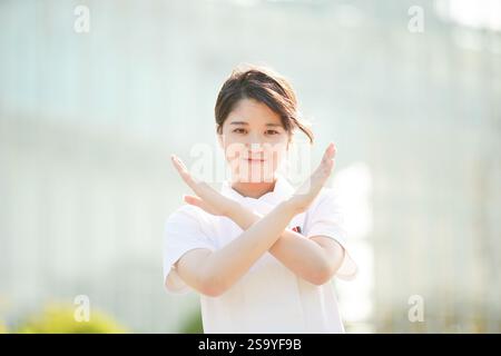 Woman in white making the ‘Butu’ sign Stock Photo - Alamy