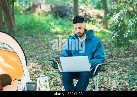 Men working while camping Stock Photo - Alamy