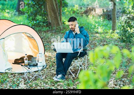 Men working while camping Stock Photo - Alamy