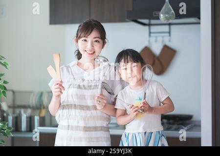 Parents and children trying cooking Stock Photo - Alamy