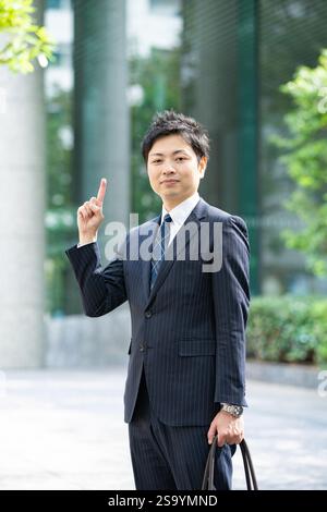 Businessman making the ‘number one’ pose Stock Photo - Alamy