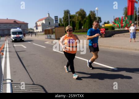 An unfocused background image of a group of athletes participating in a ...
