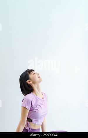 Woman taking deep breaths between yoga poses Stock Photo - Alamy