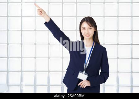 Woman in suit striking a pointing pose Stock Photo - Alamy
