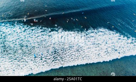 Aerial view of a lot of surfers during surfing on ocean waves. Waves ...