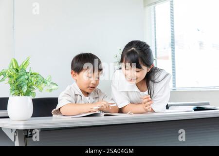 Primary schools student doing homework Stock Photo - Alamy