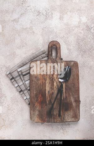 square wooden cutting board with a handle and spices on a white ...