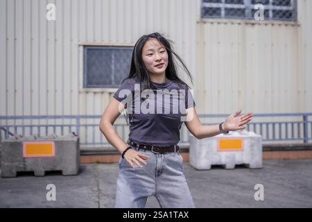 Female asian young artist dancing K-pop korean dance alone in the city ...