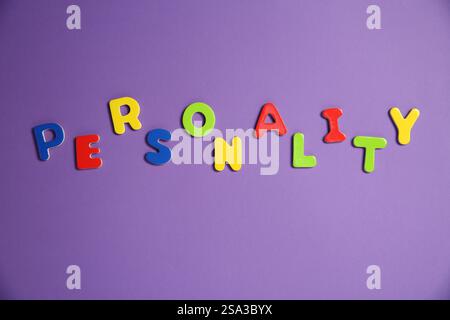 Word Personality made of colorful letters and red human figure on light ...