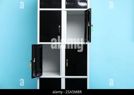 Modern lockers with keys on light blue background, space for text Stock ...