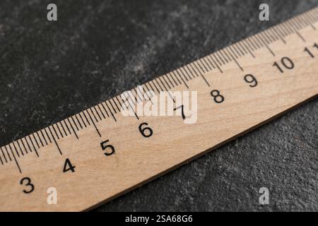 One wooden ruler on black table, top view. Space for text Stock Photo ...
