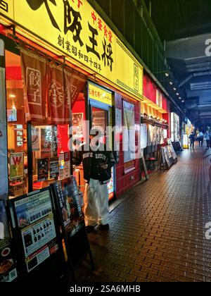 Night scene in Akabane in Tokyo, Japan with a bridge, people and a ...