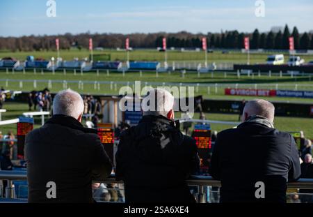 A racegoer in the pre-parade ring at Sandown Park Racecourse, Esher ...