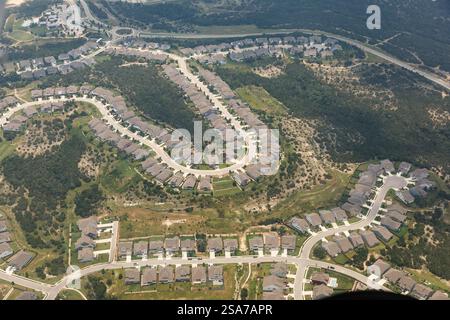 Aerial view of spiral pattern of tract housing suburban subdivision ...