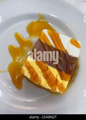 Three flavours ice cream with toffee syrup Stock Photo - Alamy