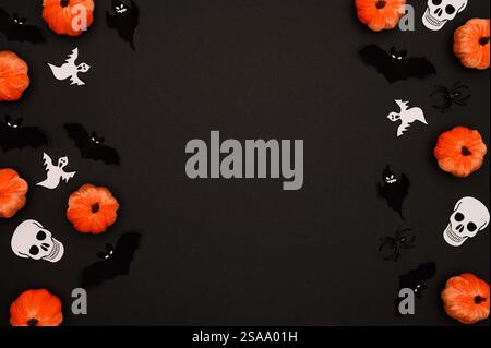 Halloween concept - black bats and skulls on black background Stock ...