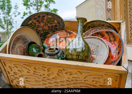 Traditional Uzbek clay pots and plates in a wooden carved chest in ...