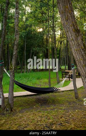 Rope cradle swing hanging on wood on the beach with wooden boat in ...
