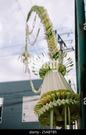 Traditional Balinese Penjor decoration made of woven coconut leaves ...