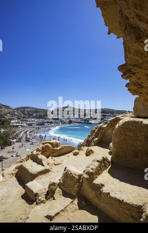 View from the rock caves to the beach of Matala, south coast, Crete ...