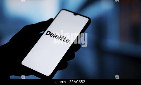 Deloitte logo is displyed on smartphone. Deloitte is a multinational ...