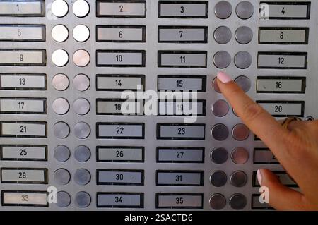 woman is calling on the intercom Stock Photo - Alamy