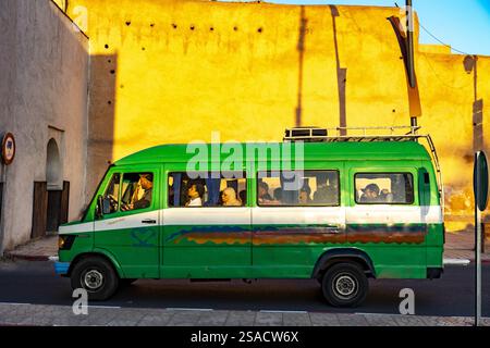 Green bus with passengers in Marrakesh, Morocco. Green bus with ...
