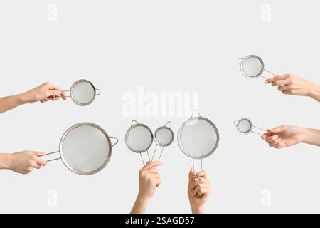 Female hands with sieves on white background Stock Photo - Alamy