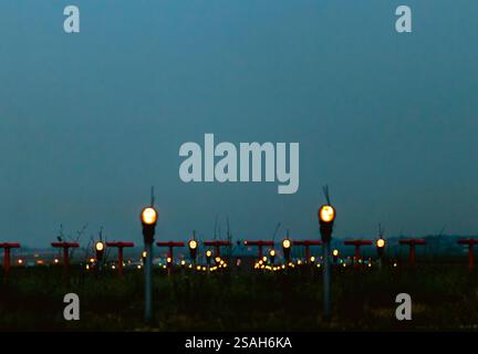 Blurred lines of runway lights at an airport. Evening time Stock Photo ...
