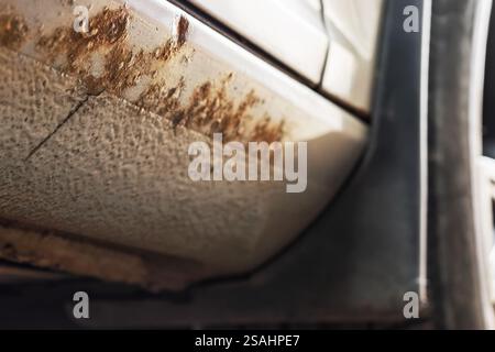 Fragment of a car body with rust. fragment of a rusty wing of a car ...