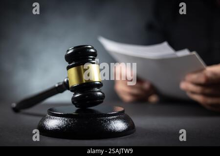 Judge's gavel and papers against judge background Stock Photo - Alamy