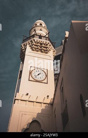 Abdulla Ali Yateem Mosque square minaret with four clocks and decorate ...