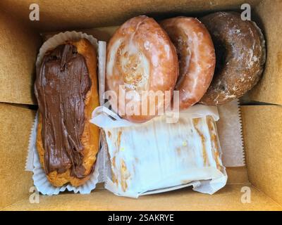 top view of chocolate in a box on orange background Stock Photo - Alamy