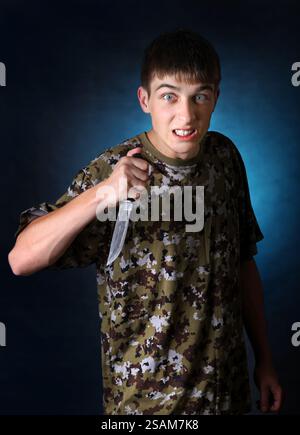 Angry YOung Man with a Knife On the Dark Background Stock Photo - Alamy