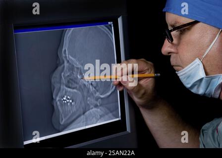 A medical doctor examining a CTT Scan Stock Photo - Alamy