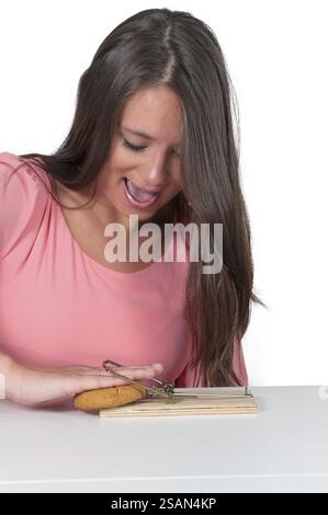 Beautiful woman using the mouse trap diet plan Stock Photo - Alamy