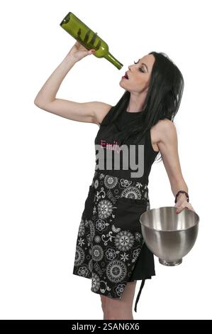 Beautiful woman chef drinking a bottle of wine Stock Photo - Alamy