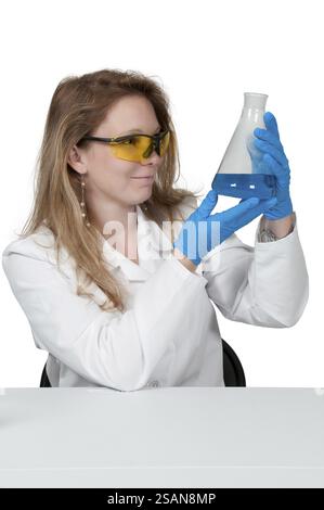 Beautiful woman scientist investigating a glass beaker Stock Photo - Alamy